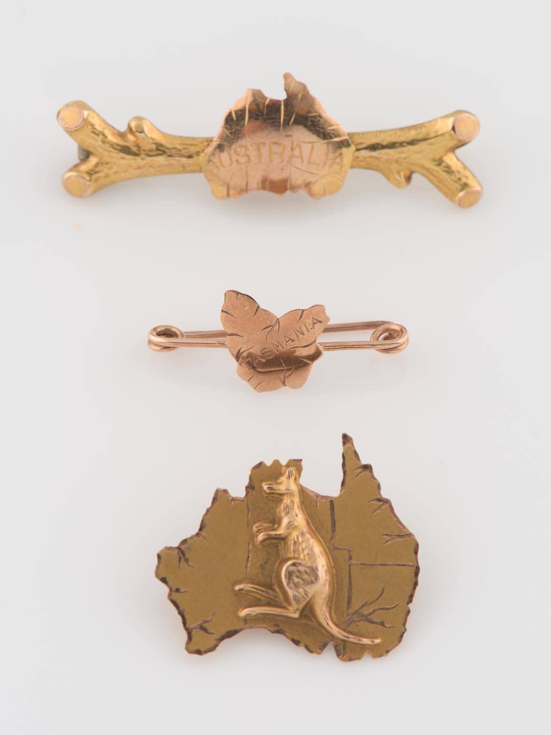Three gold brooches, one a map of Tasmania, one a kangaroo and map of ...