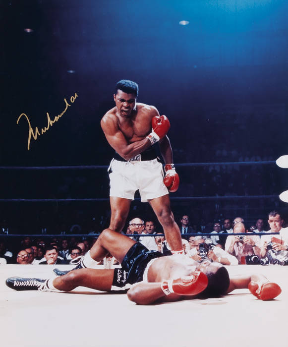 MUHAMMAD ALI, signed colour photograph of Ali standing over Sonny ...