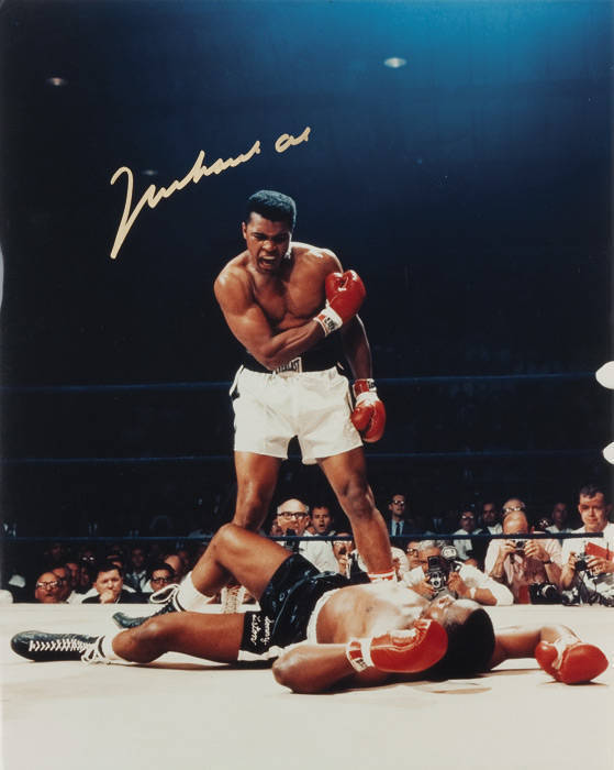 MUHAMMAD ALI, signed colour photograph of Ali standing over Sonny ...