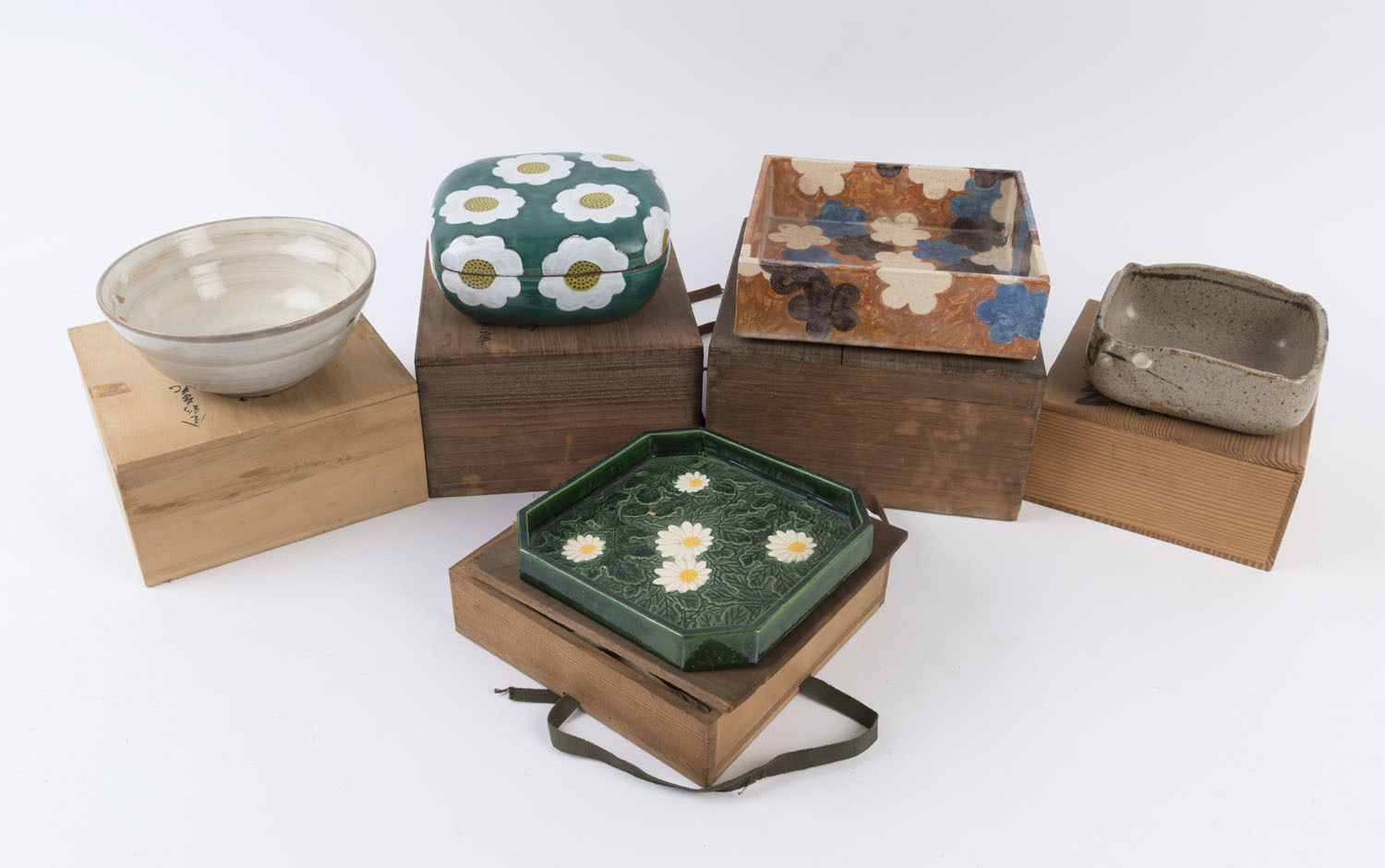 Four assorted Japanese pottery bowls and a pottery lidded box, all in ...