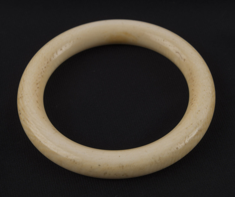 A vintage carved ivory bangle, early 20th century, formerly the ...