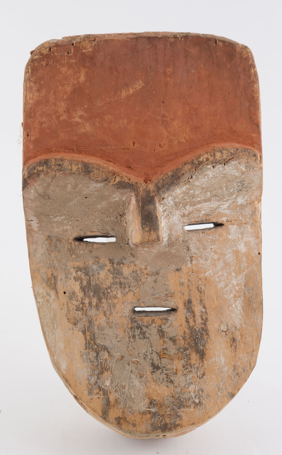 An African mask with orange forehead and slit eyes, carved wood and ...