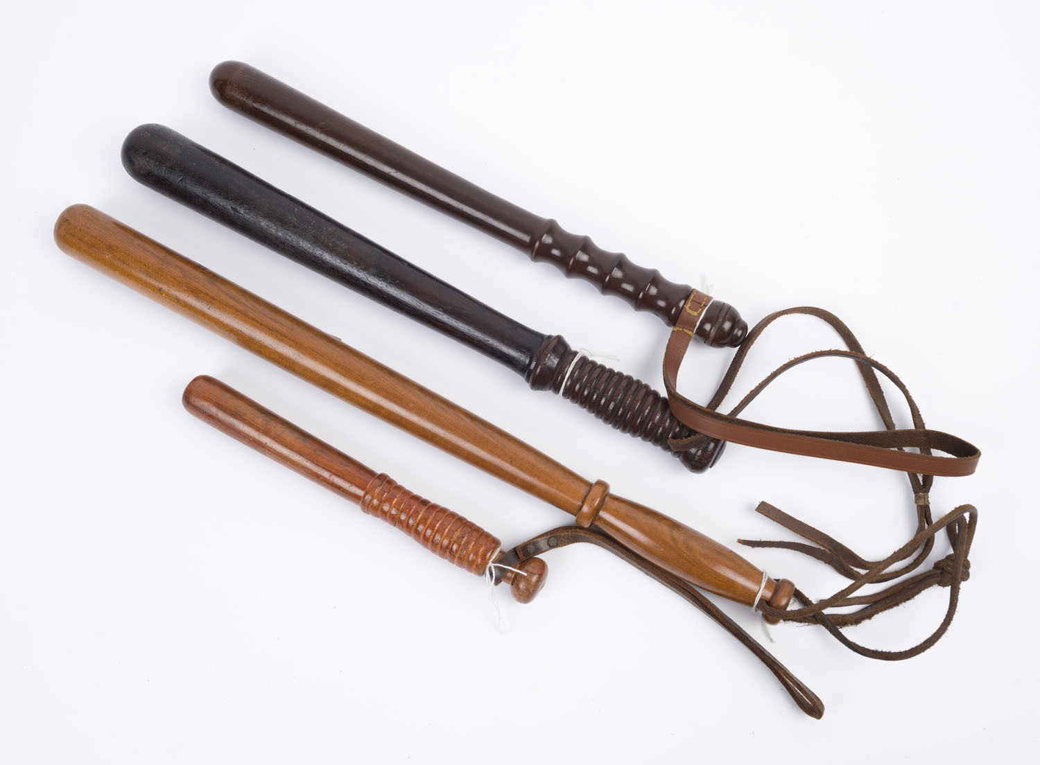 Four vintage police truncheons, 20th century, the largest 54cm long,
