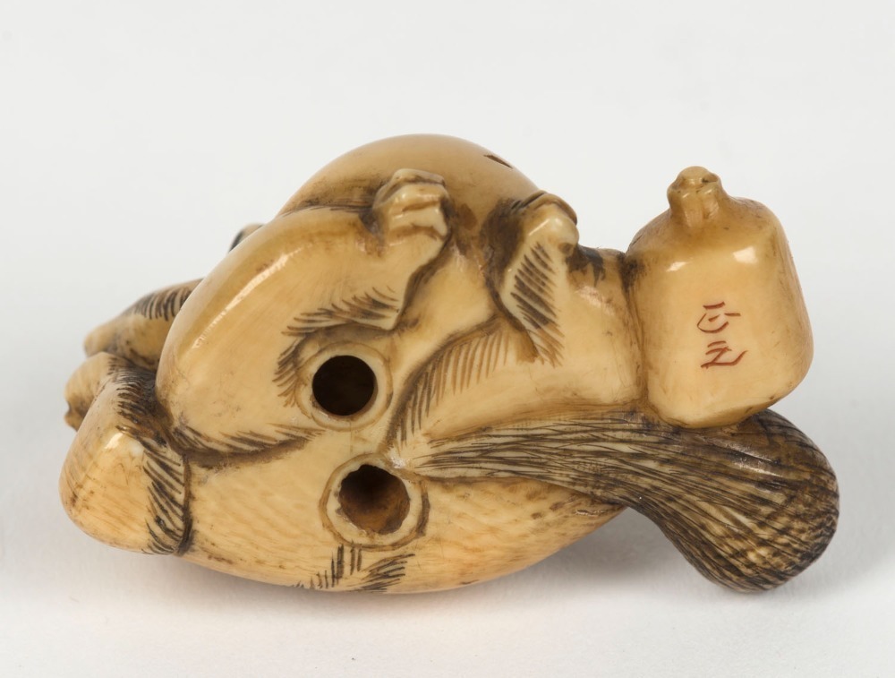 Three Japanese carved ivory netsuke in the form of a fox, man with ...