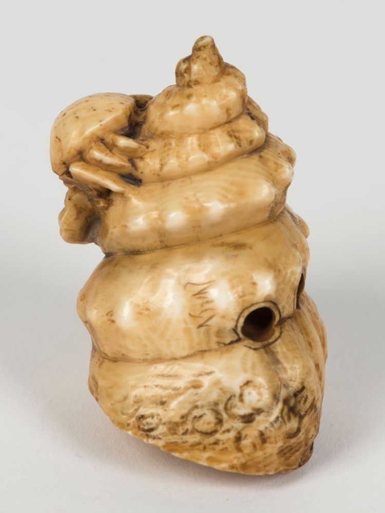 Three Japanese carved ivory netsuke in the form of a fox, man with ...