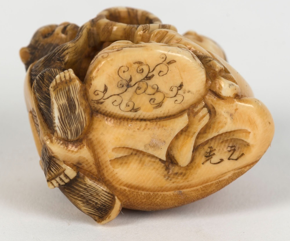 Three Japanese carved ivory netsuke in the form of a fox, man with ...