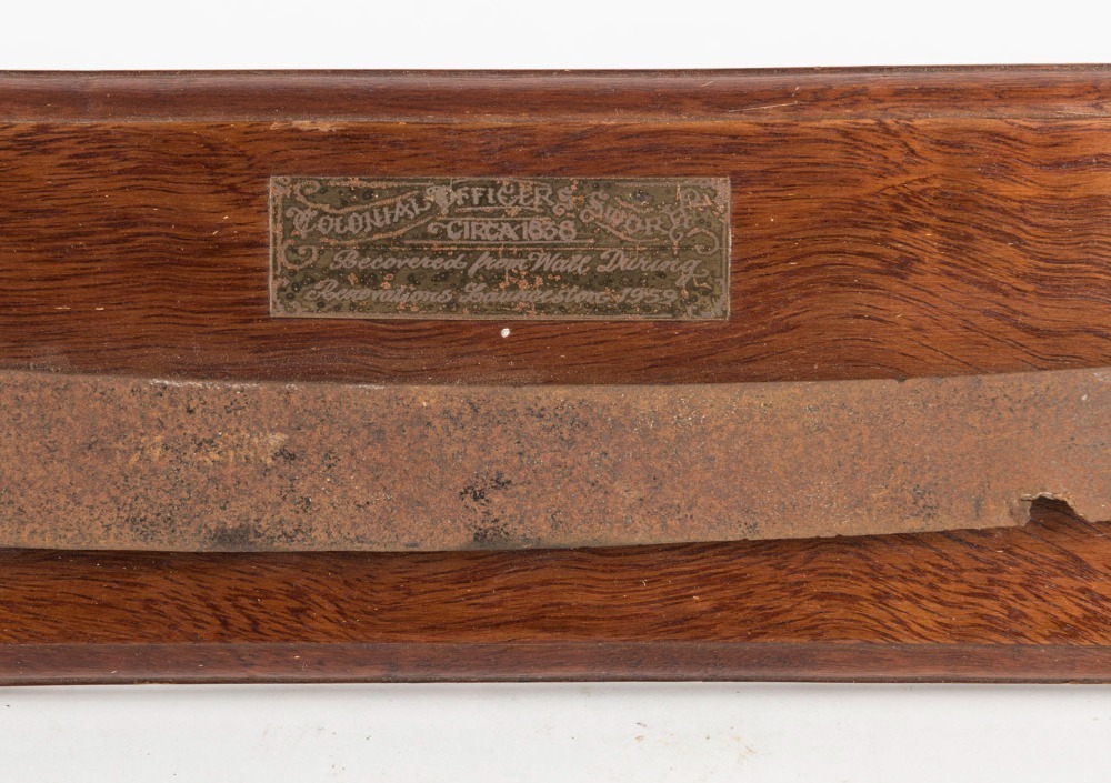 COLONIAL OFFICER'S SWORD relic condition, mounted on board with plaque ...