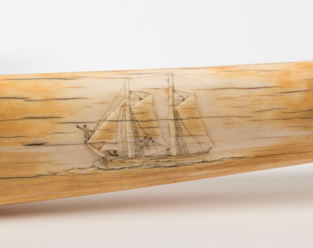 An antique walrus tusk with high relief carving of a tallship and ...