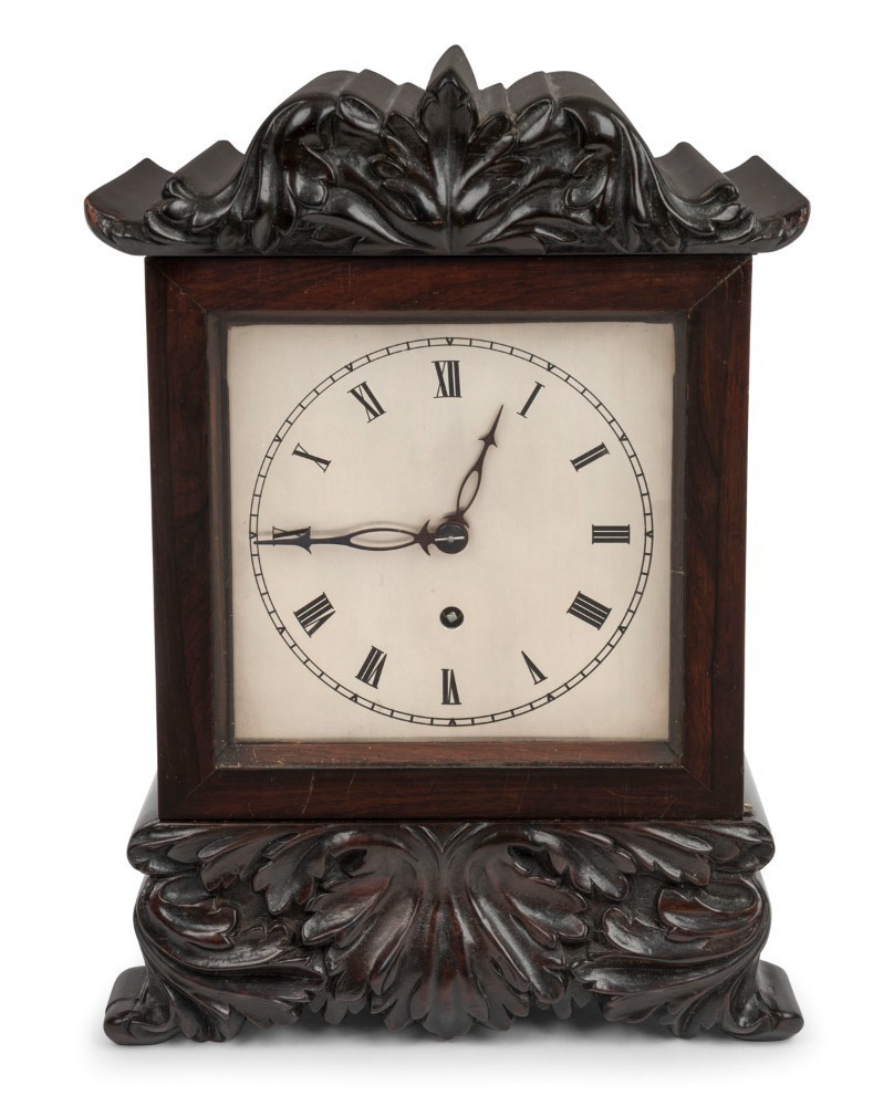 An antique English William IV four glass library clock in rosewood and ...