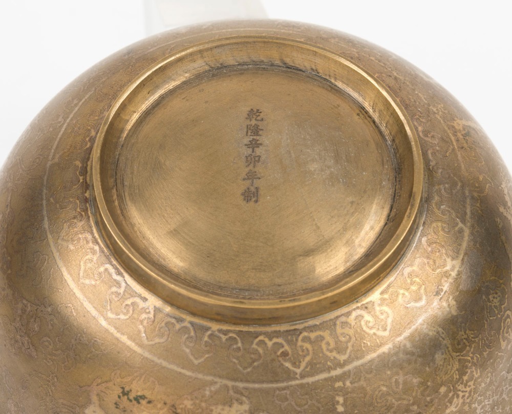 An antique Chinese bronze temple offering bowl with remains of gold ...