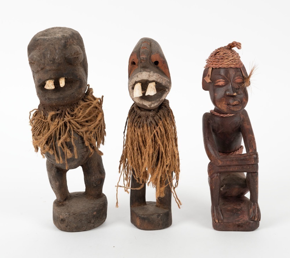 Three tribal statues, carved wood, fibre and tooth with earth pigments ...