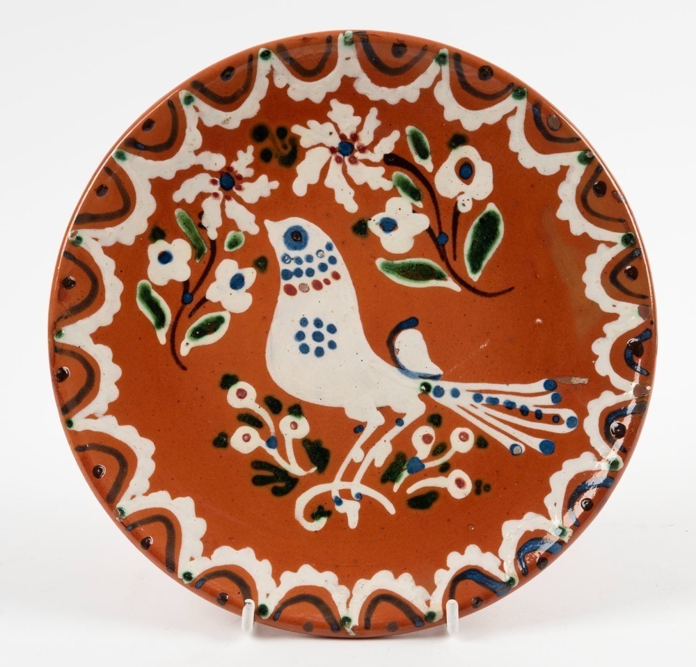 An English slip ware plate with bird decoration, inscribed on the ...