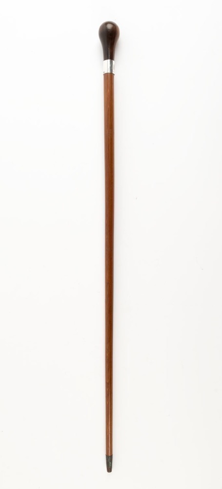 A vintage timber walking stick with engraved silver collar and brass ...