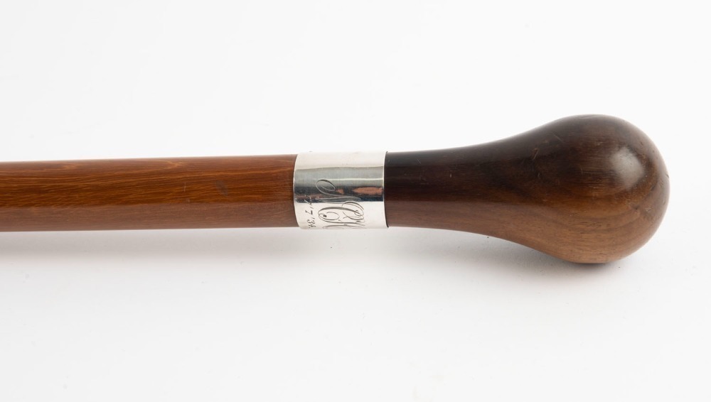A vintage timber walking stick with engraved silver collar and brass ...