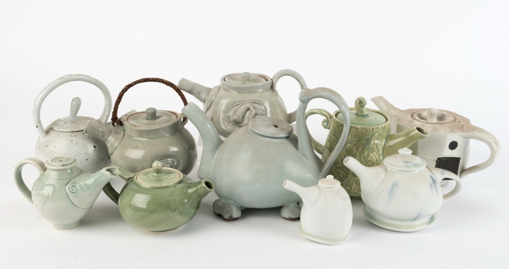 Ten assorted Australian ceramic teapots, mostly cream and green glazed ...