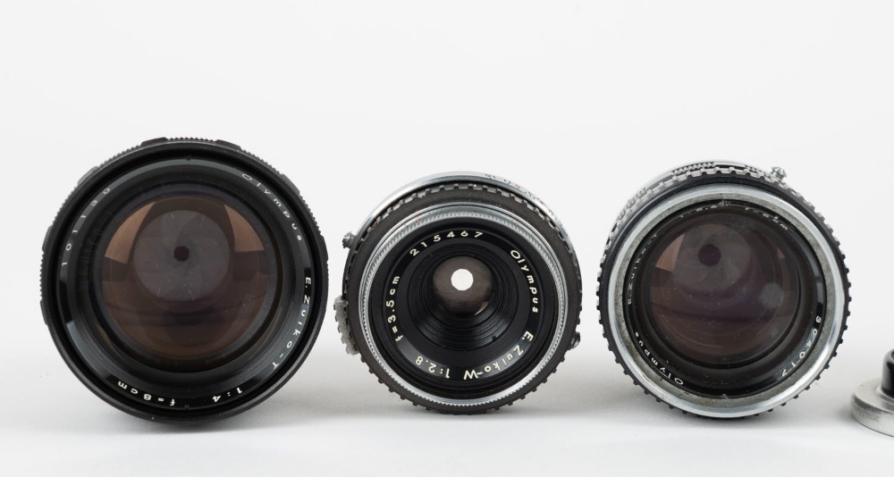 OLYMPUS: Three lenses in black and chrome with bayonet mounts for ...