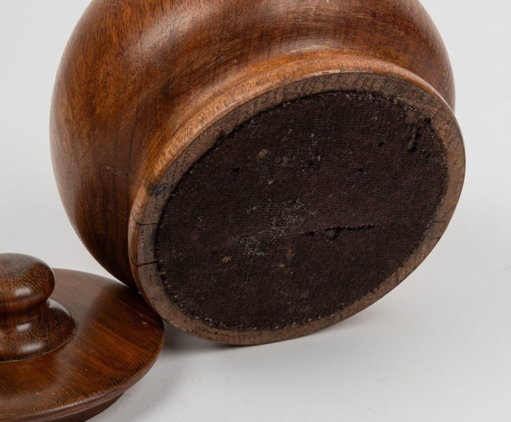 A carved blackwood lidded pot, with silver plaque affixed under the lid ...