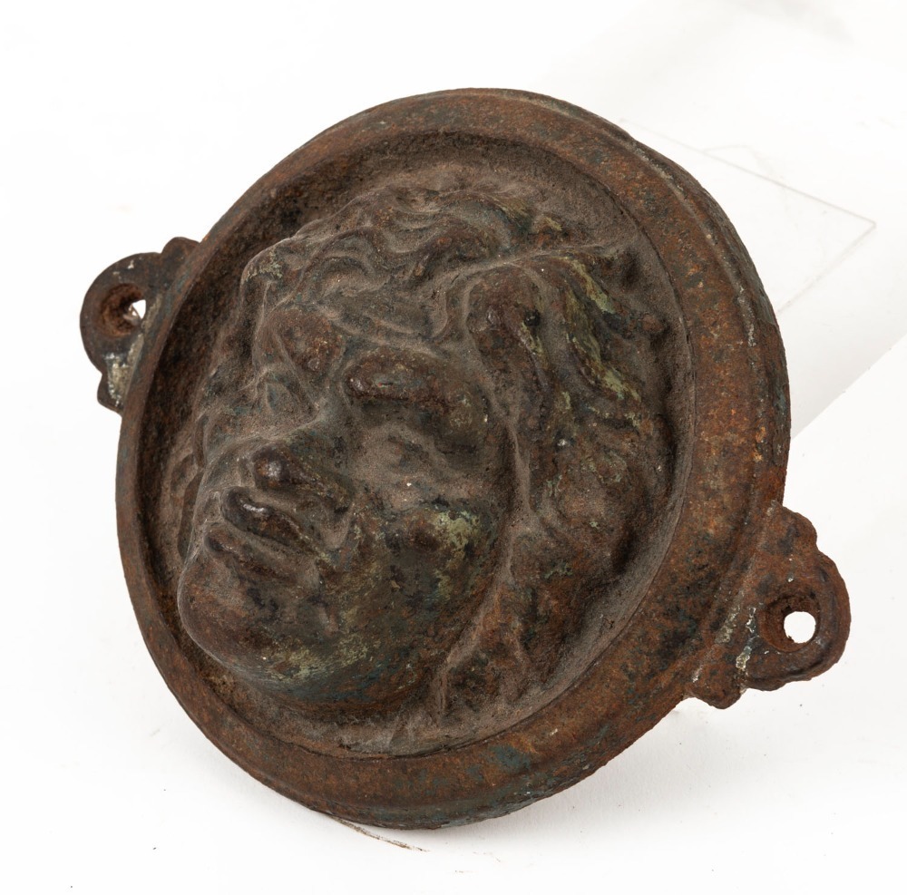 Aboriginal face cast iron architectural roundel, 19th century, 16cm wide