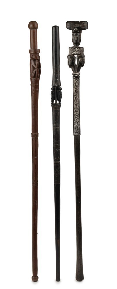 Three chieftain's walking sticks, carved wood with piped clay ...