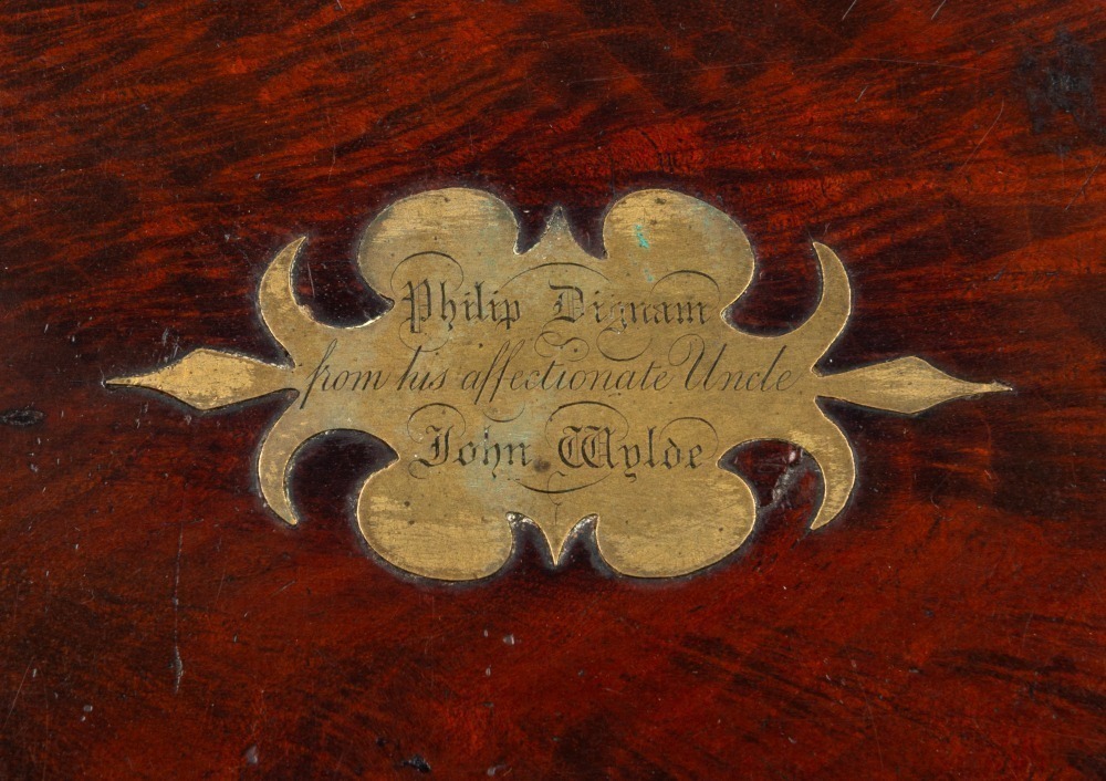 An antique travelling dressing set housed in a brass-bound flame ...