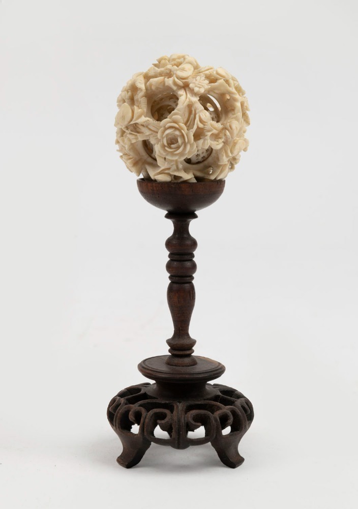 An antique Chinese carved ivory puzzle ball on turned rosewood stand ...