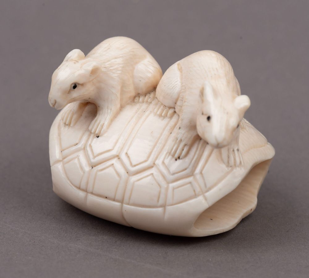 Three Japanese carved ivory netsukes comprising: turtle, rats and ...