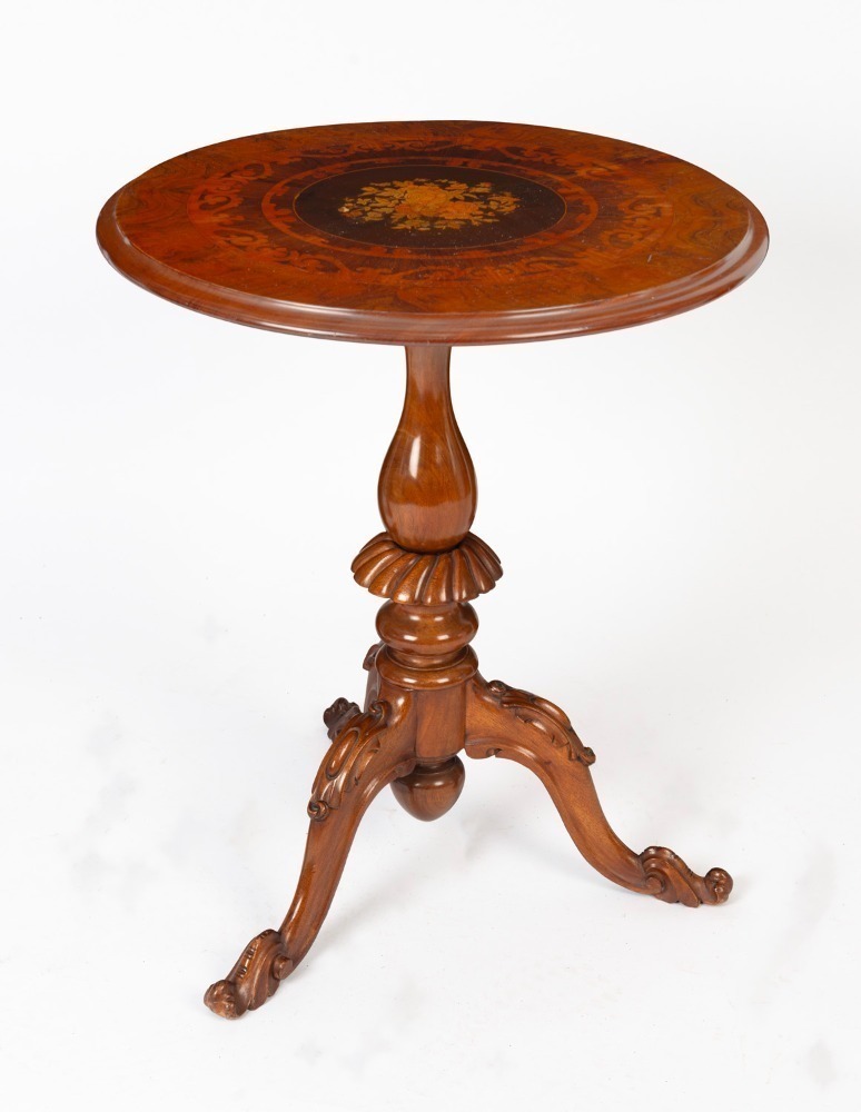An antique English carved walnut wine table with circular floral ...
