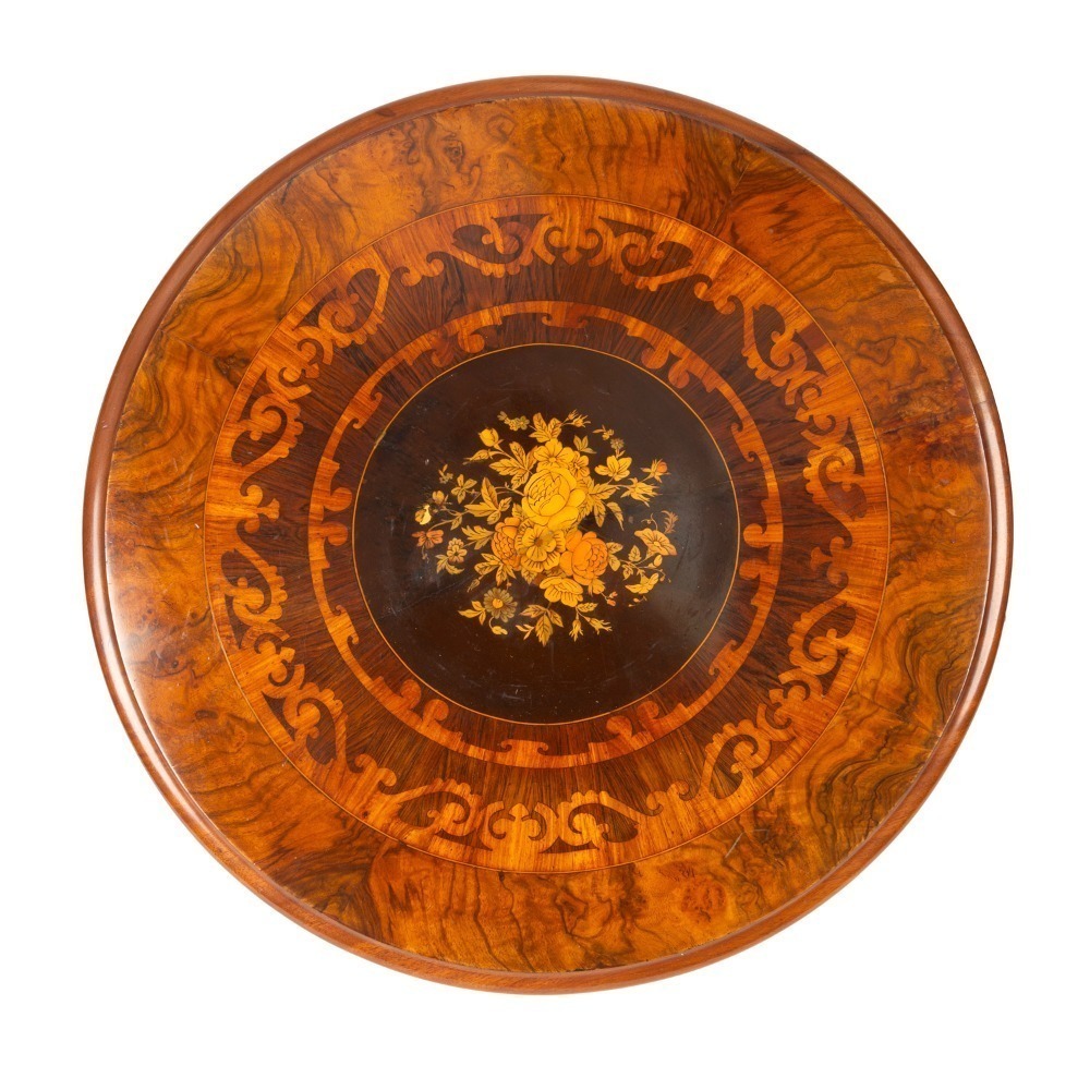 An antique English carved walnut wine table with circular floral ...