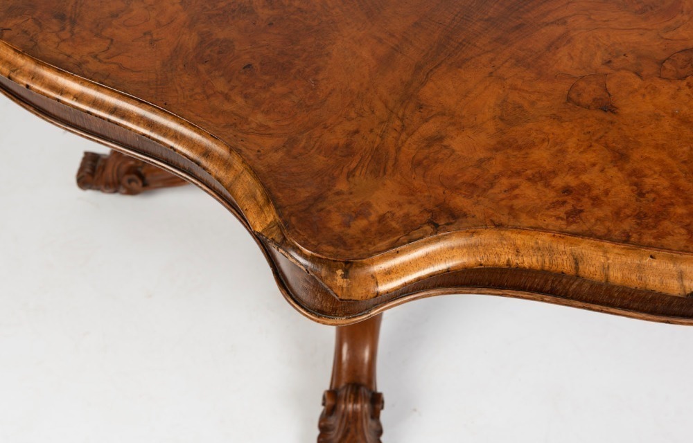 An antique English walnut centre table with quarter book matched burr ...