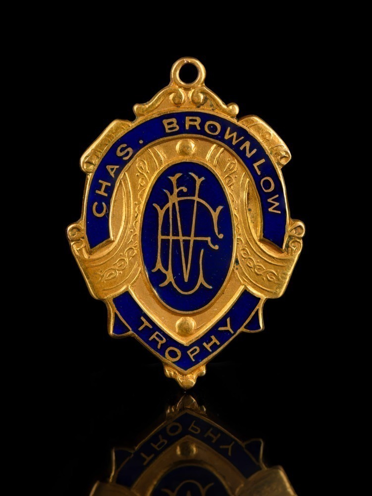 THE 1966 BROWNLOW MEDAL, 9ct gold, blue enamel; engraved verso ...