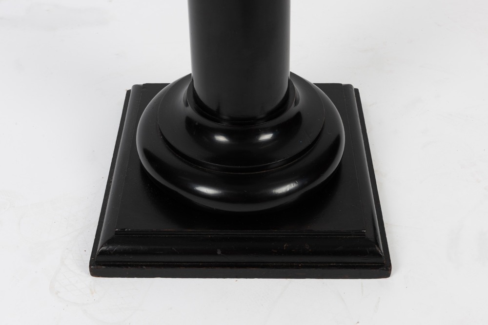 An antique English ebonised pedestal, turned column with single reeded ...