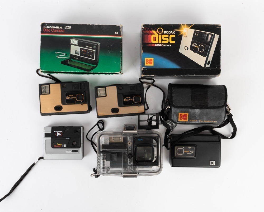 VARIOUS MANUFACTURERS: Eight c. 1980s disc-film cameras - one Ansco ...