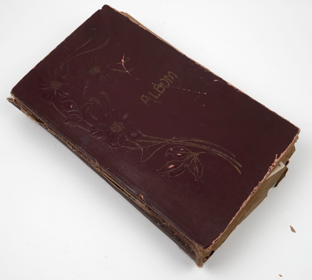 Postcard album (dilapidated) with large range of cards including ...