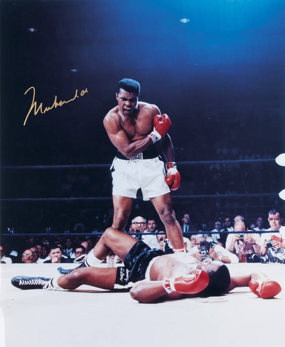 MUHAMMAD ALI, signed colour photograph of Ali standing over Sonny ...